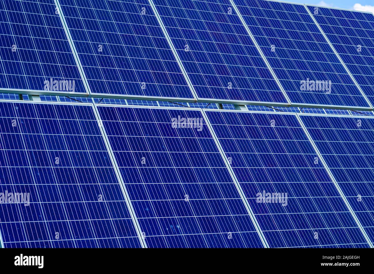 Solar panels on blue sky background Stock Photo - Alamy