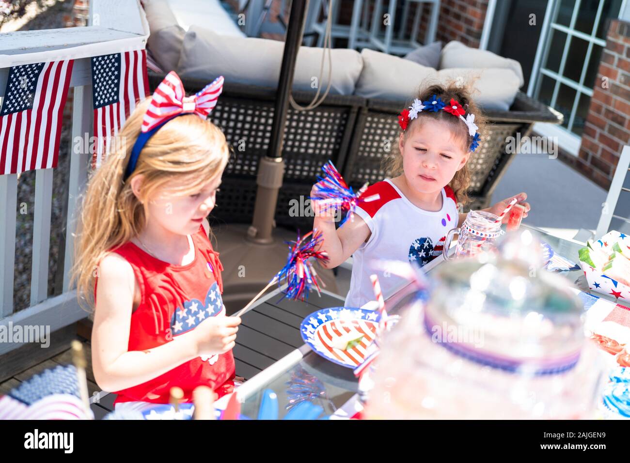 Little girls are playing at the July 4th party on the back patio Stock ...