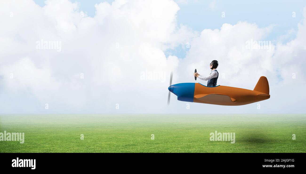 Man in airplane flying low above green meadow. Aviator driving small ...