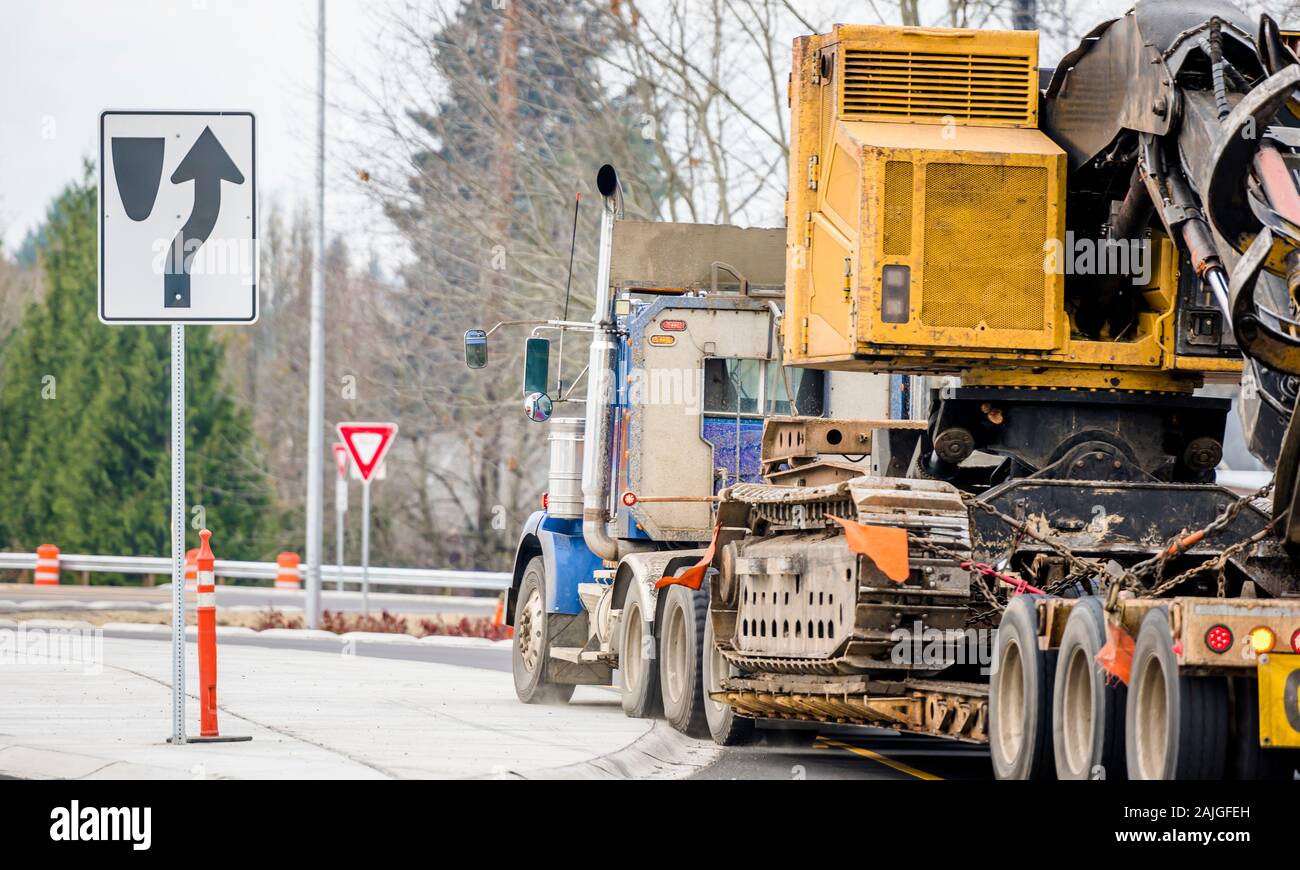 Blue big rig heavy duty classic bonnet semi truck with oversize load ...