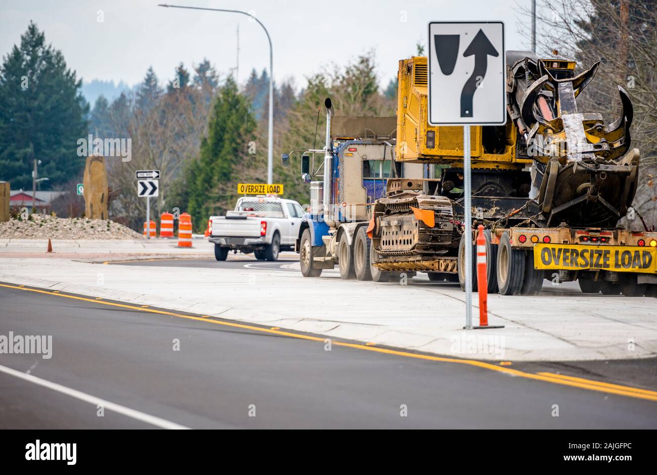 Blue big rig heavy duty classic bonnet semi truck with oversize load ...