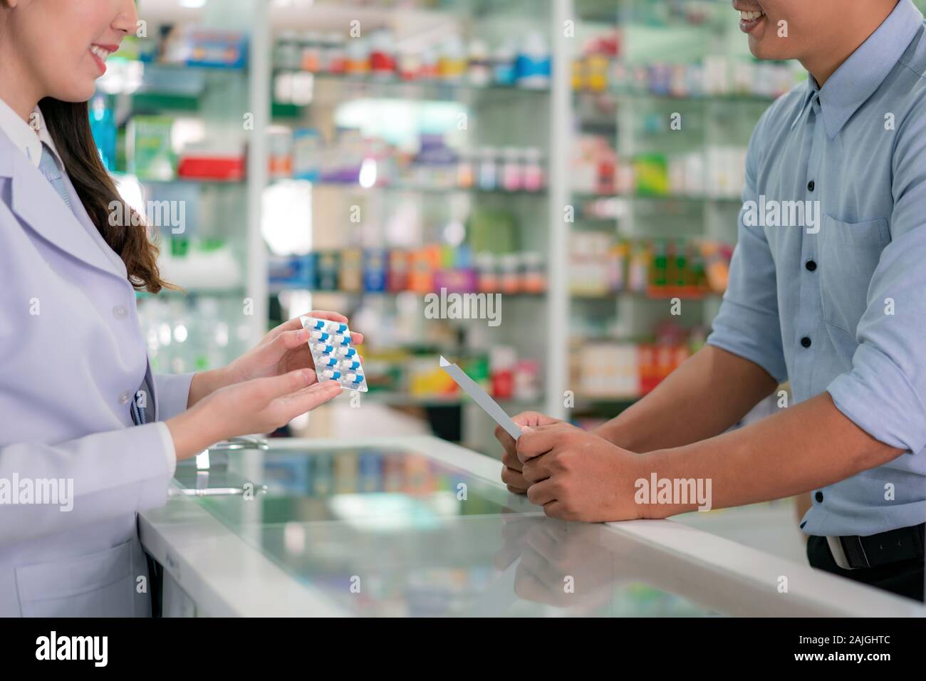 Confident Asian young female pharmacist with a lovely friendly smile ...