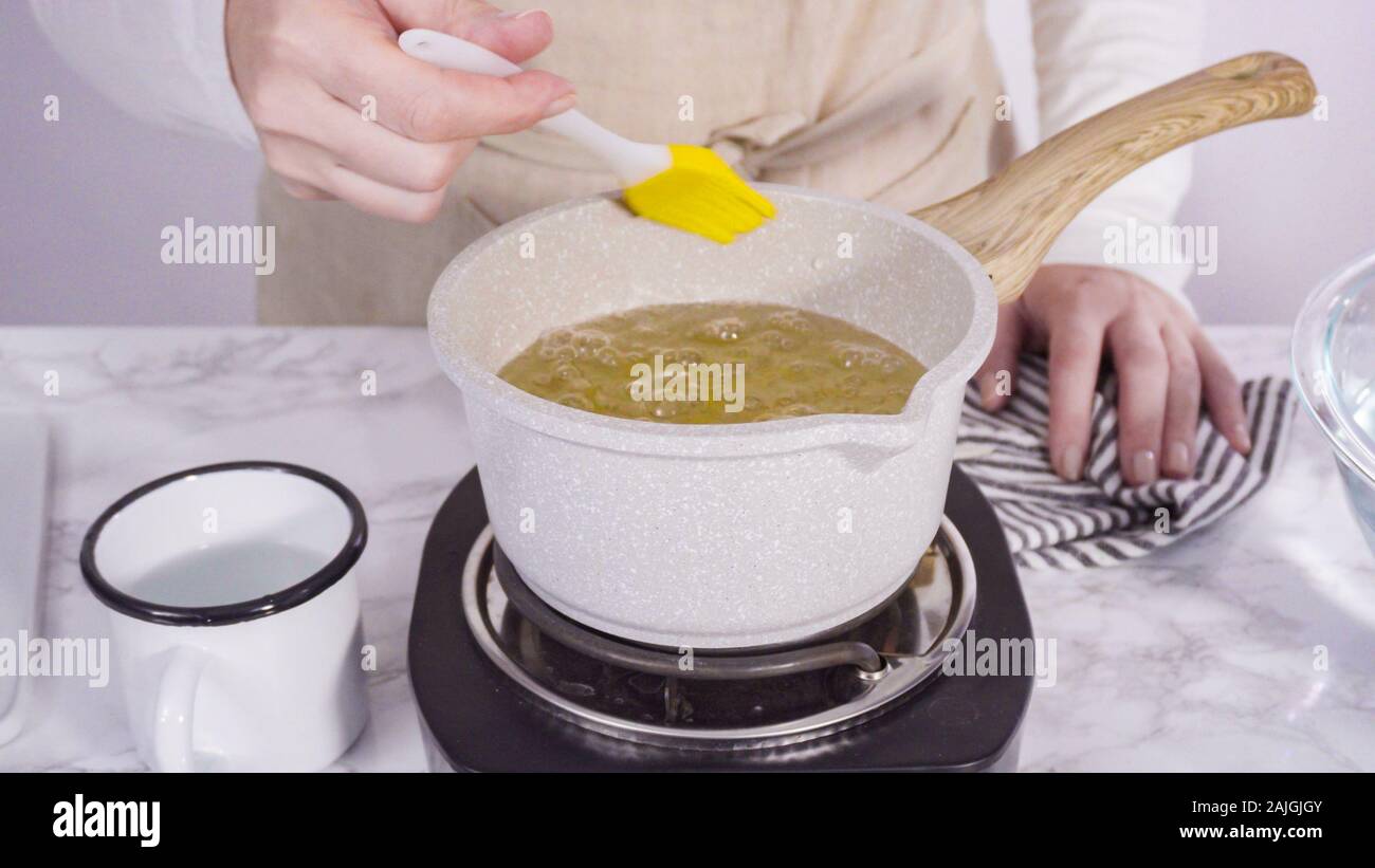 Step by step. Caramelizing sugar in a small cooking pot over the small ...