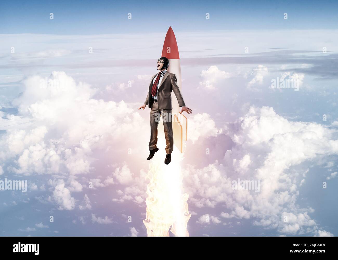 Businessman in suit and aviator hat flying on rocket in stratosphere ...