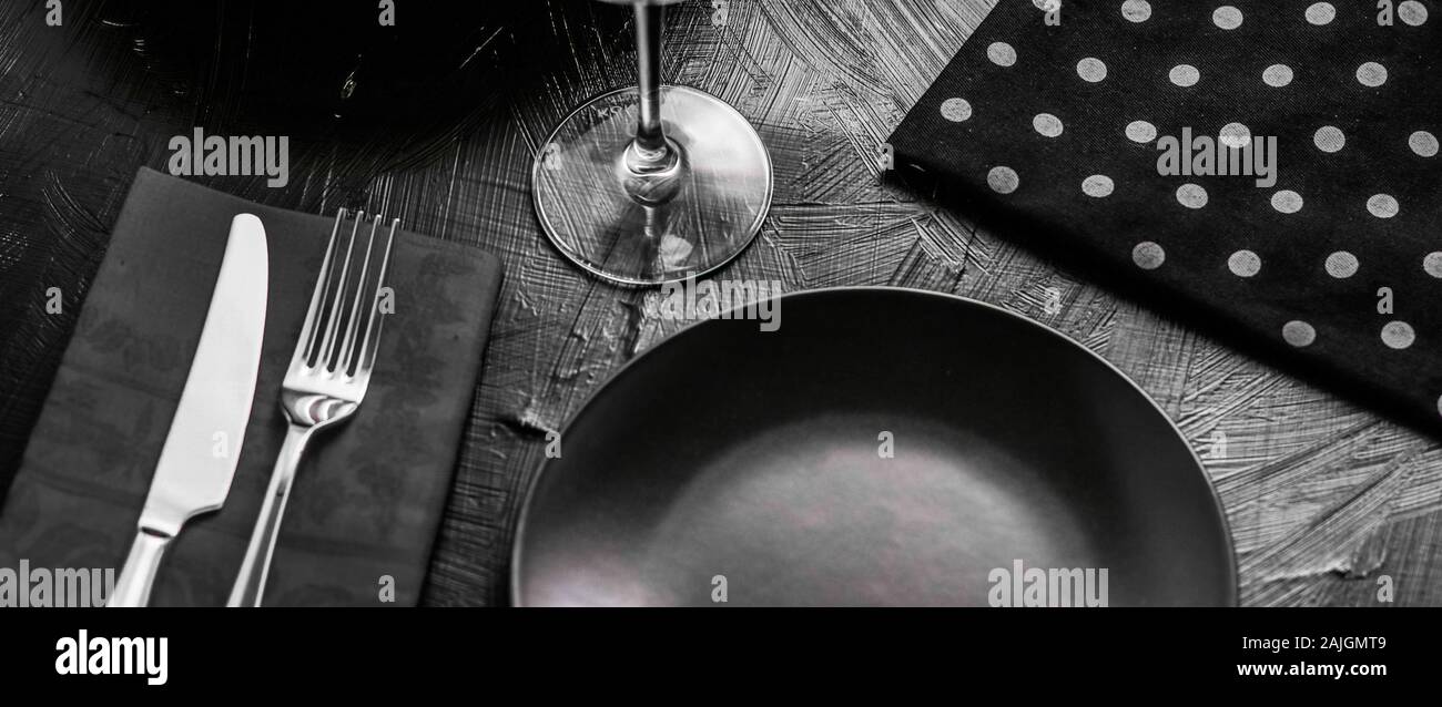 Dishware, menu and table concept - Empty tableware with black napkin ...