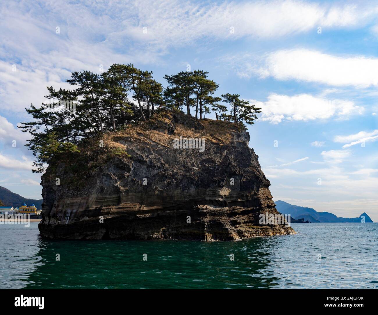 Dogashima, Japan. A marine sedimentary rock, trees growing on top of it ...