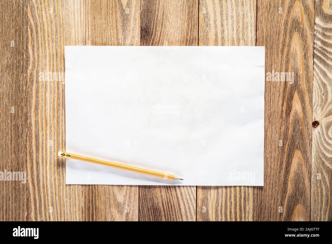 Artist workplace with sheet of paper and pencil lying on wooden desk ...