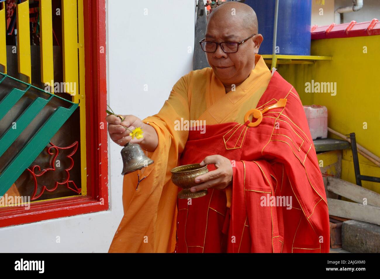 A Buddhist priest is blessing a temple before The Chinese New Year ...