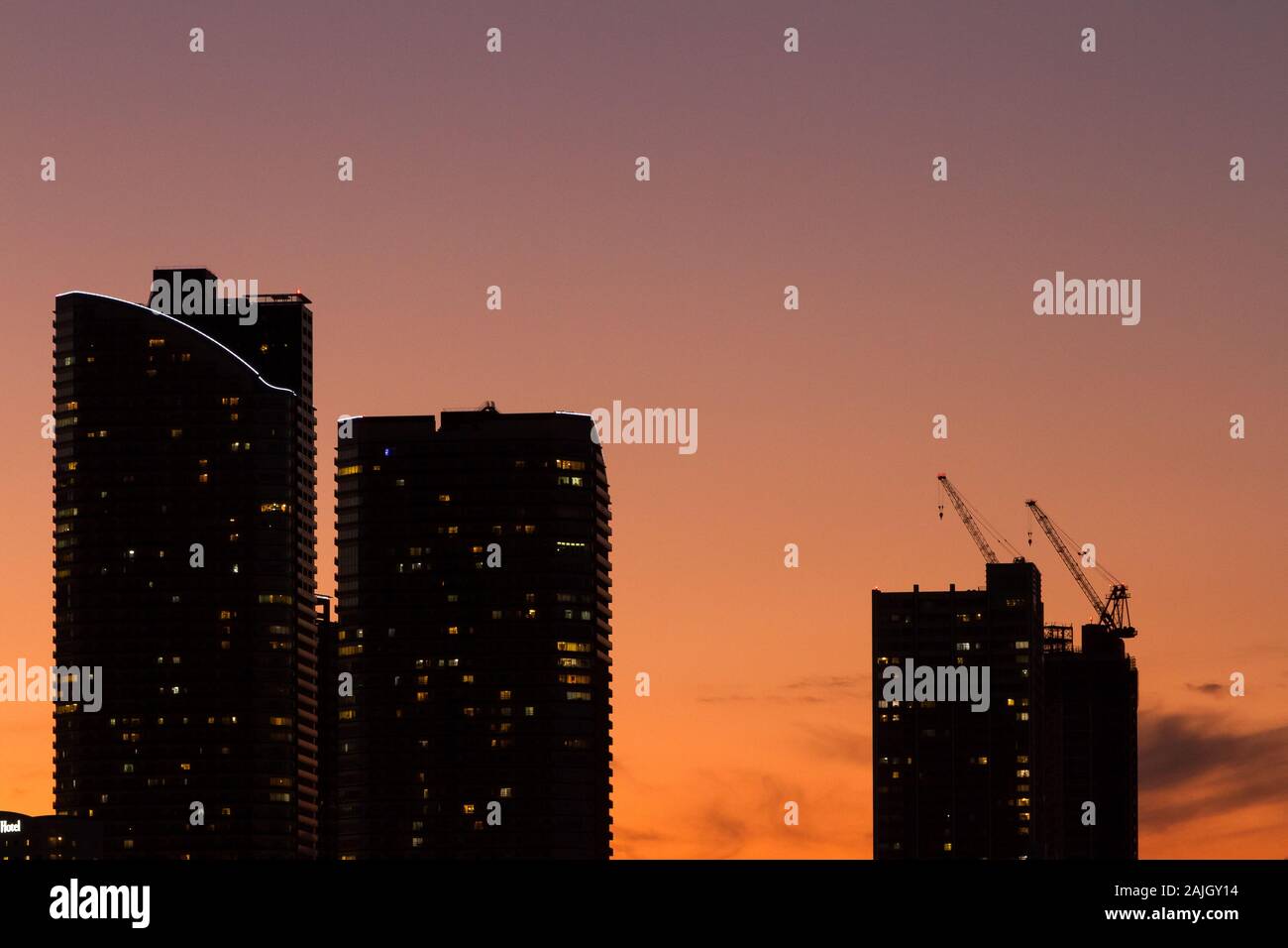 Apartment buildings, office towers and construction site cranes at ...