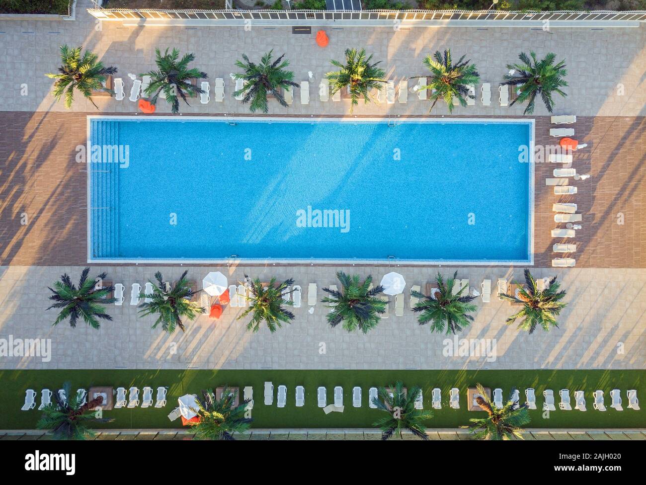 Top down aerial view of hotel swimming pool with crystal blue water ...