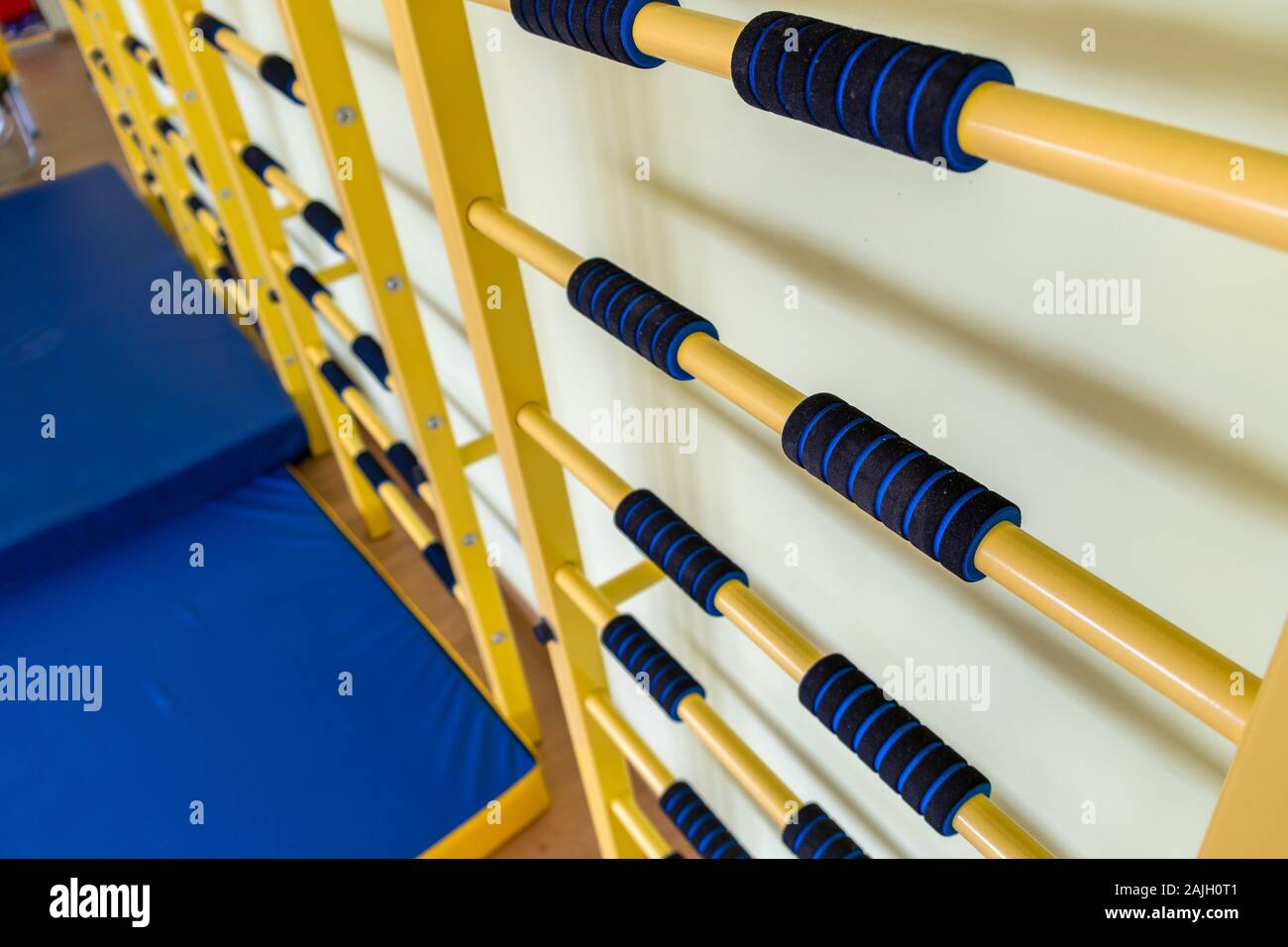 A wall with ladder bar for fitness training inside sports gym room in a ...