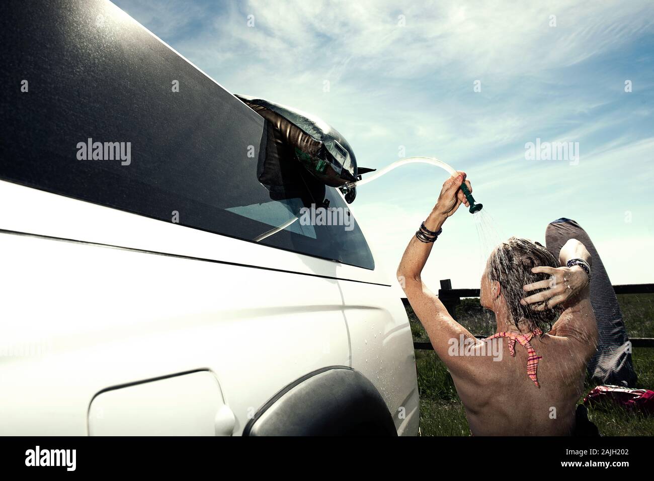 woman surfer has post surf shower from truck Stock Photo - Alamy