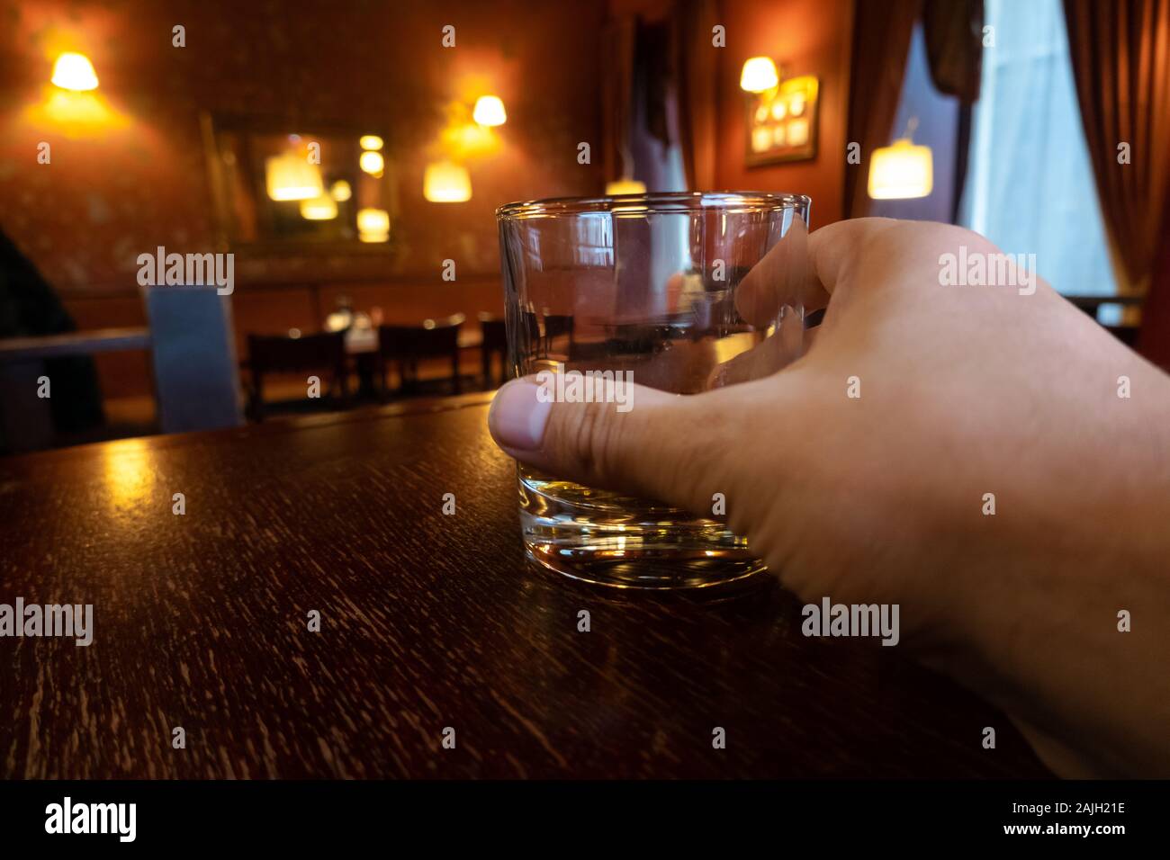 Hand holding empty drinking glass hi-res stock photography and images ...