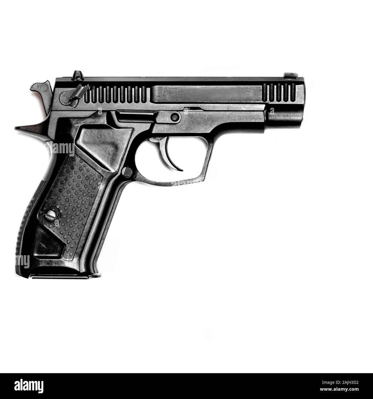 A black gun lies against a white background. Isolated. View from above ...