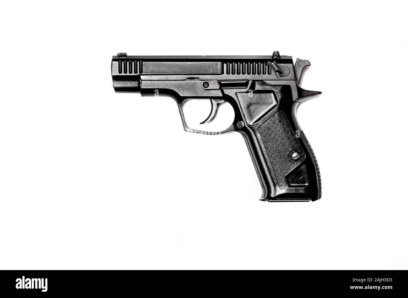 A black gun lies against a white background. Isolated. View from above ...