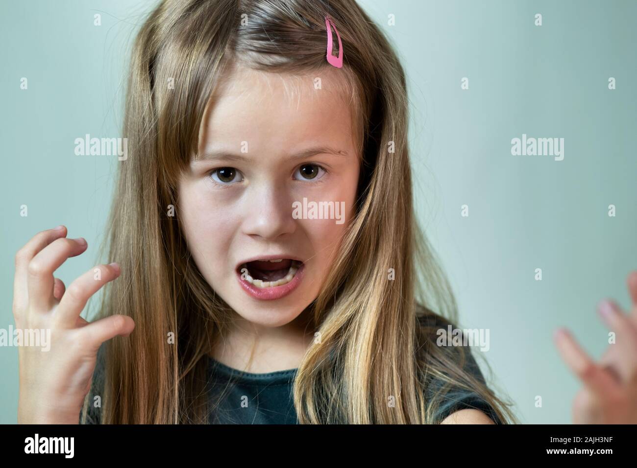 Close up portrait of angry shouting child girl looking aggressively in ...