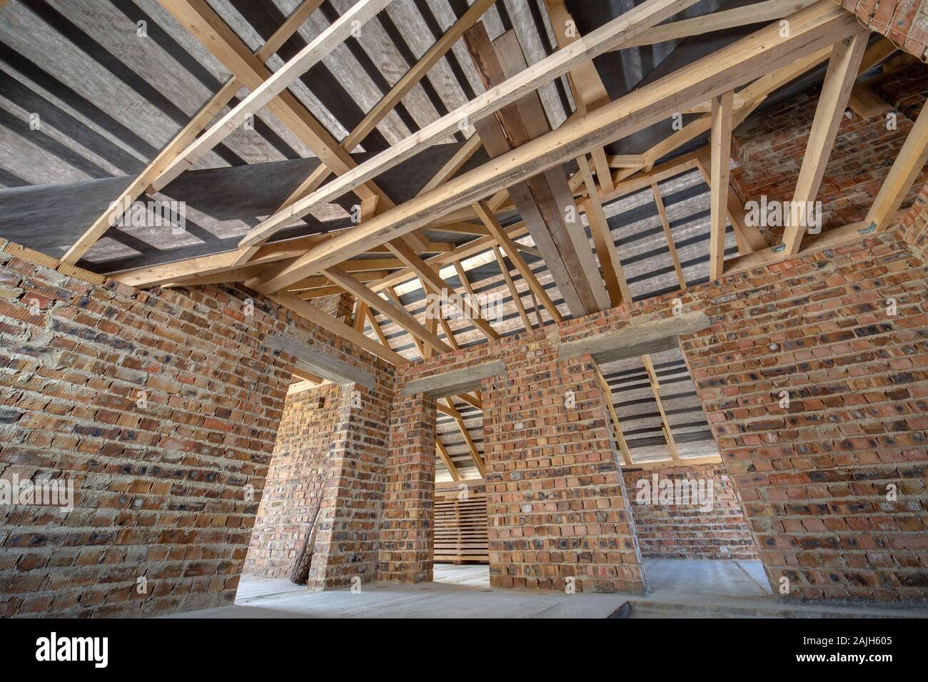 Attic of a building under construction with wooden beams of a roof ...