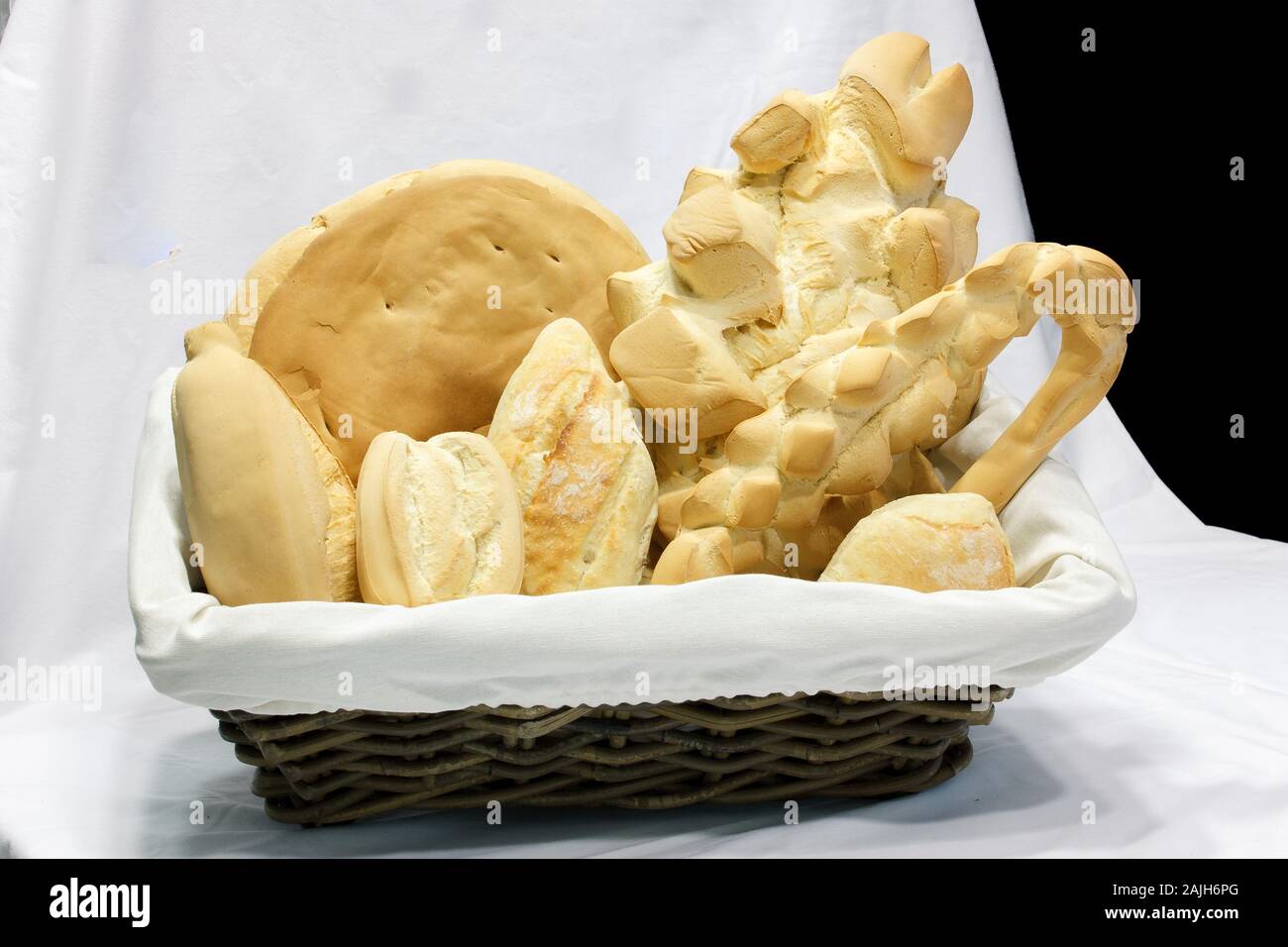 Wicker basket with different types of delicious bread Stock Photo - Alamy