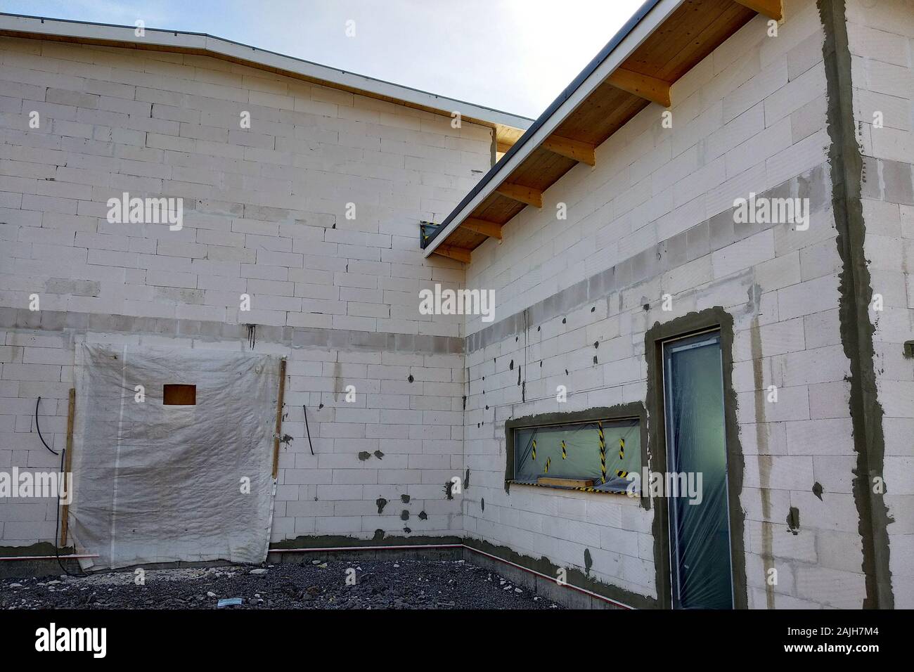 Facade of white block building under construction works Stock Photo - Alamy