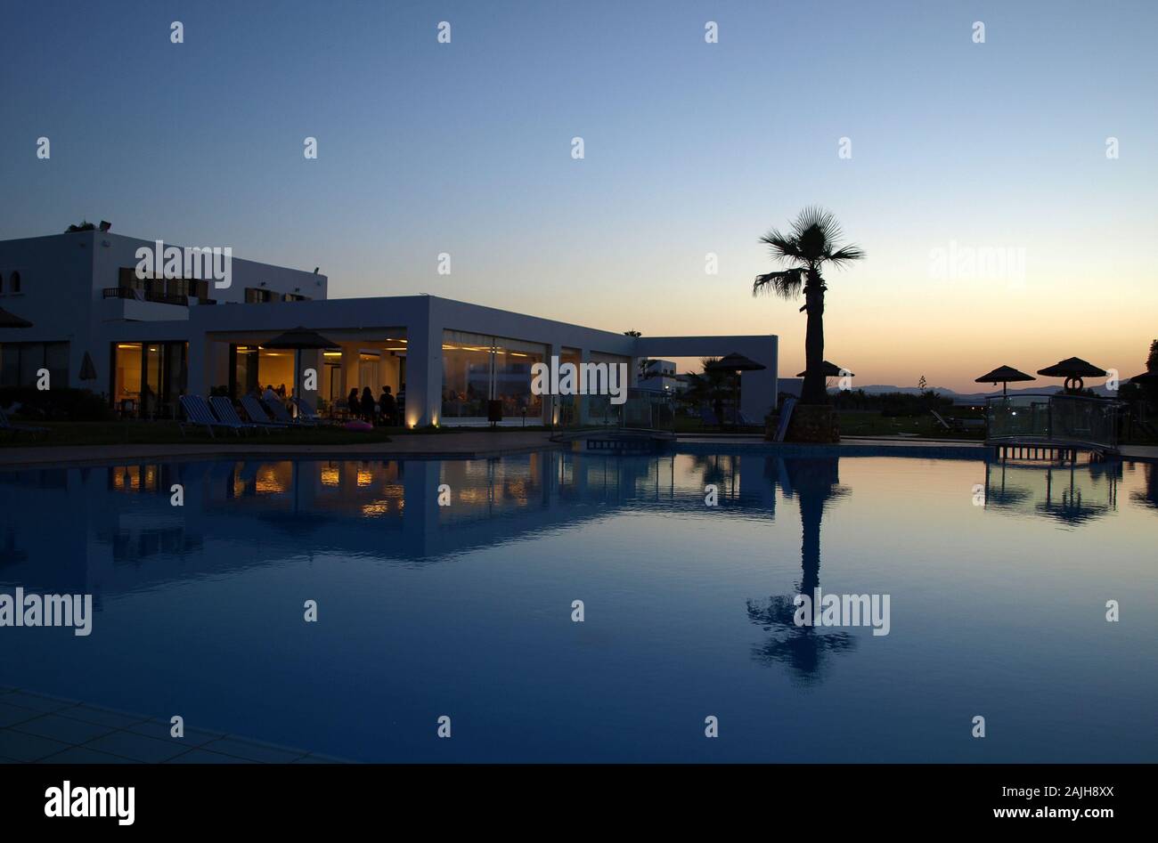 Swimming pool of luxury hotel at dusk Stock Photo - Alamy