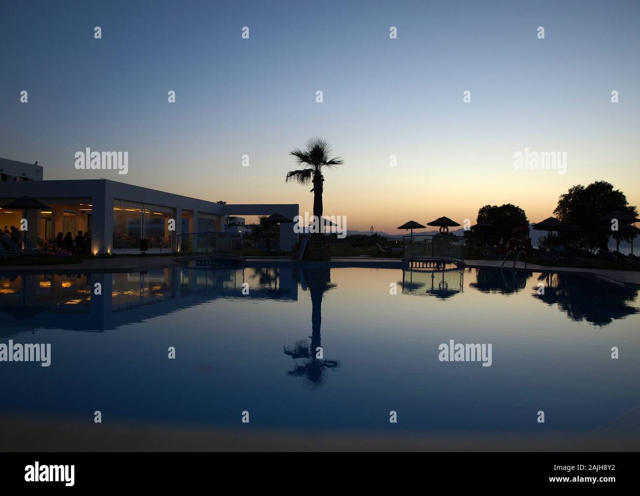 Swimming pool of luxury hotel at dusk Stock Photo - Alamy