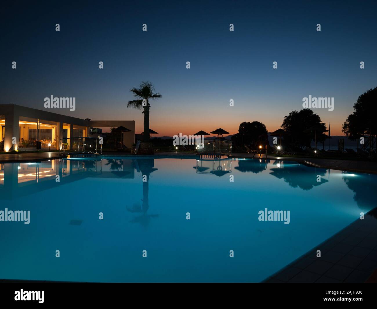Swimming pool of luxury hotel at dusk Stock Photo - Alamy