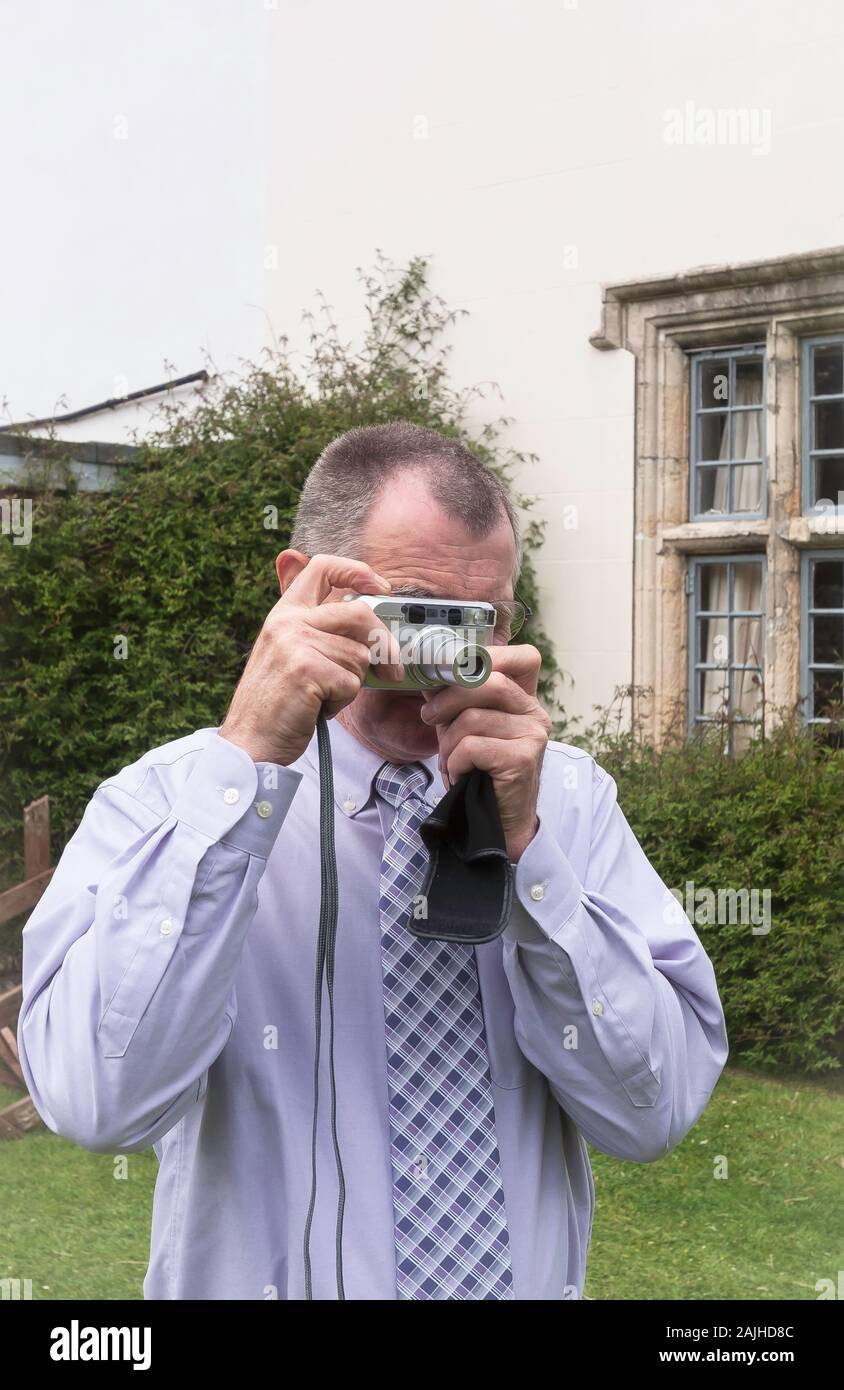 Man hold with a camera at party Stock Photo - Alamy