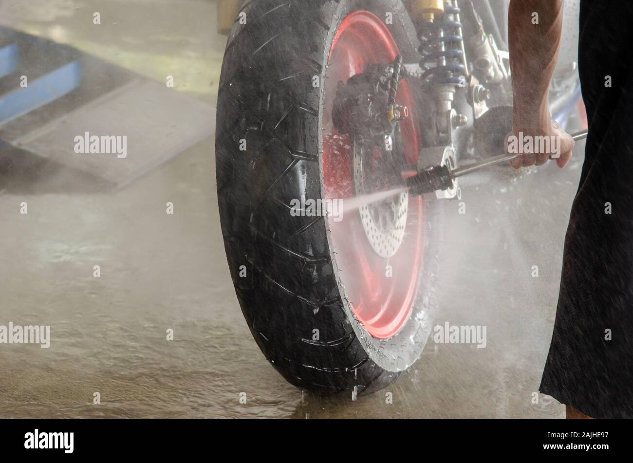 man hand is cleaning with a high-pressure water gun, washing a ...