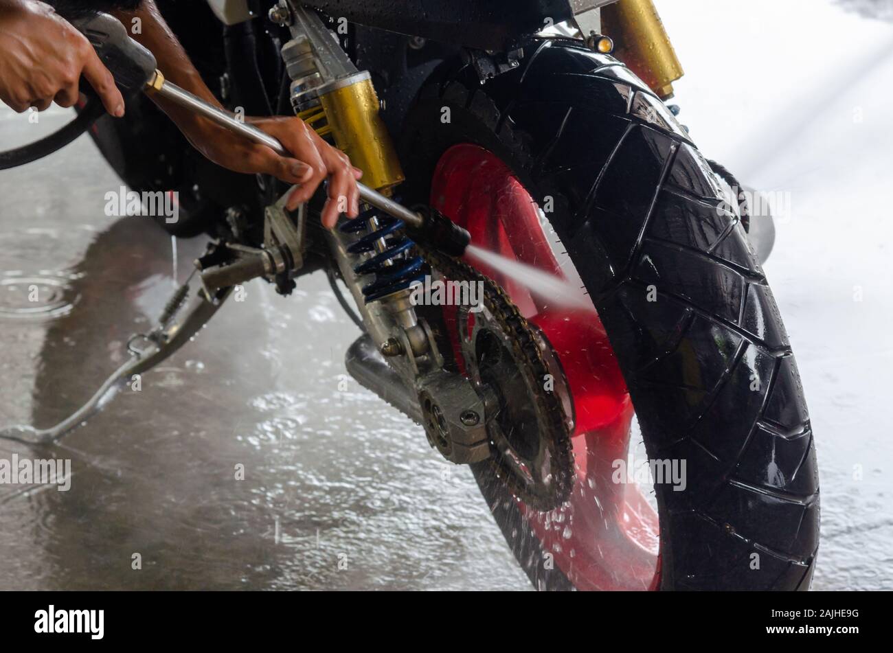 man hand is cleaning with a high-pressure water gun, washing a ...