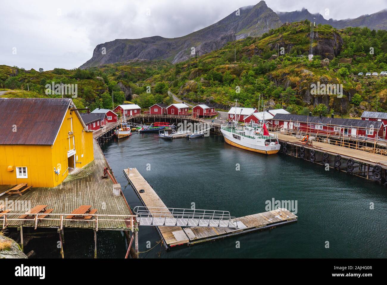 Traditional yellow wooden houses, rorbuer in the small fishing village ...