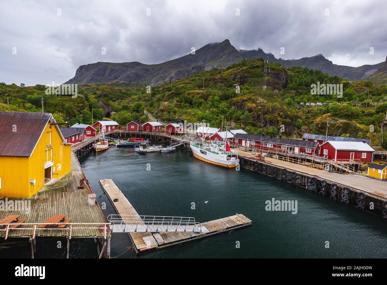 Traditional yellow wooden houses, rorbuer in the small fishing village ...
