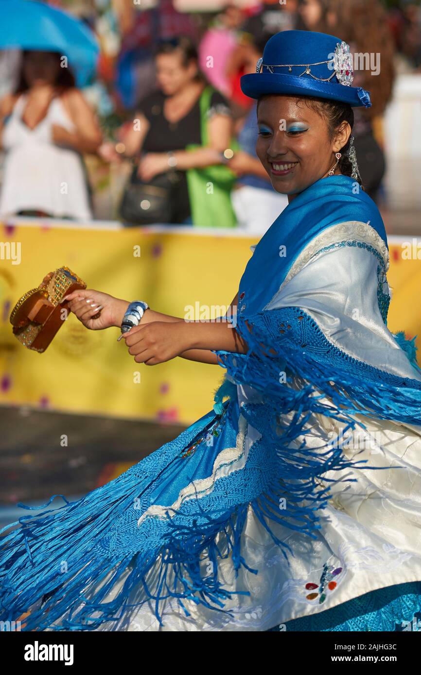Female members of a Morenada dance group in ornate costumes performing ...