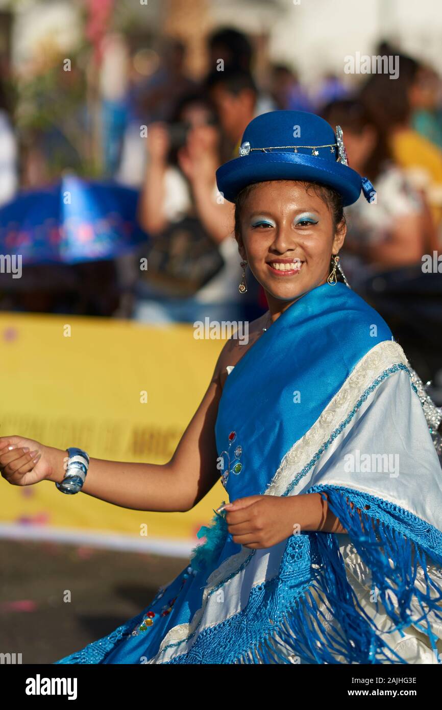 Female members of a Morenada dance group in ornate costumes performing ...