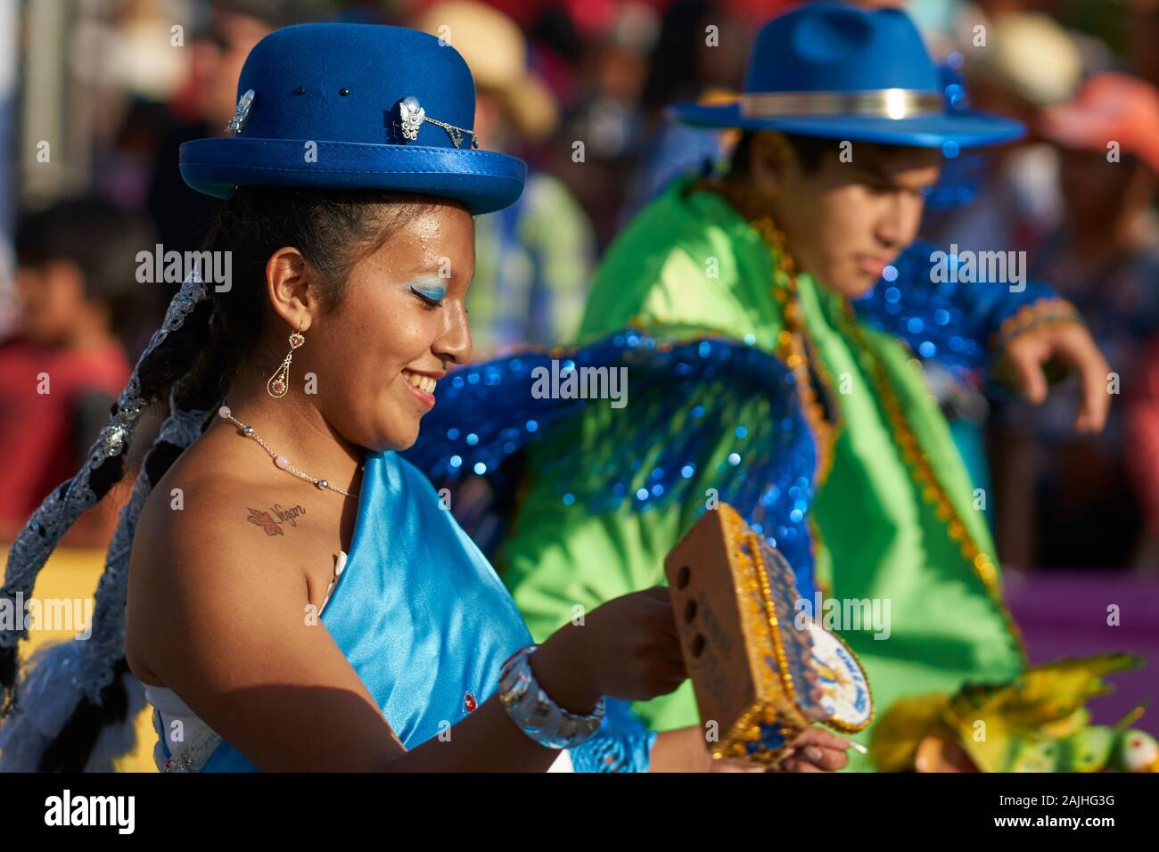 Female members of a Morenada dance group in ornate costumes performing ...