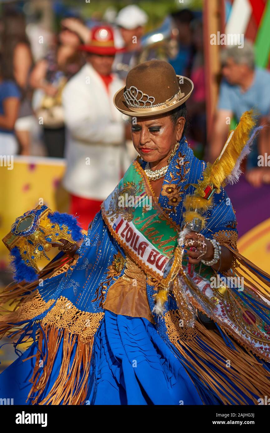Female members of a Morenada dance group in ornate costumes performing ...