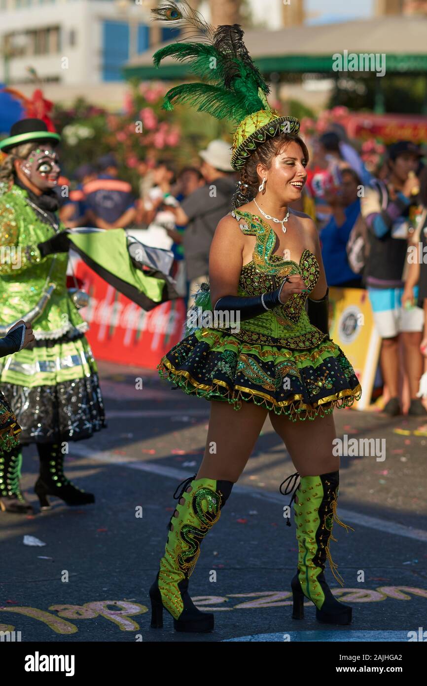 Female members of a Morenada dance group in ornate costumes performing ...