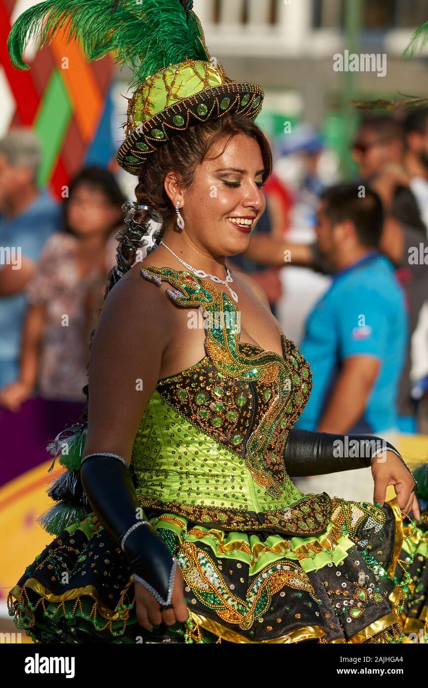 Female members of a Morenada dance group in ornate costumes performing ...