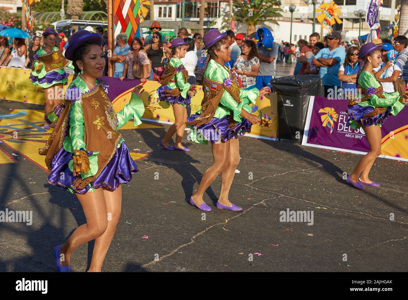 Female members of a Morenada dance group in ornate costumes performing ...