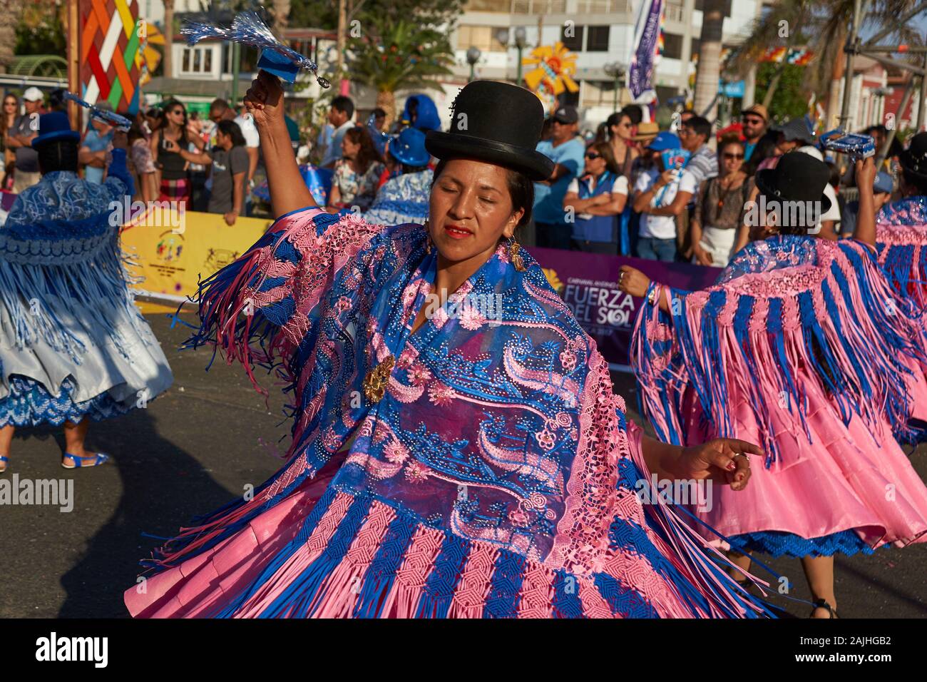 Female members of a Morenada dance group in ornate costumes performing ...