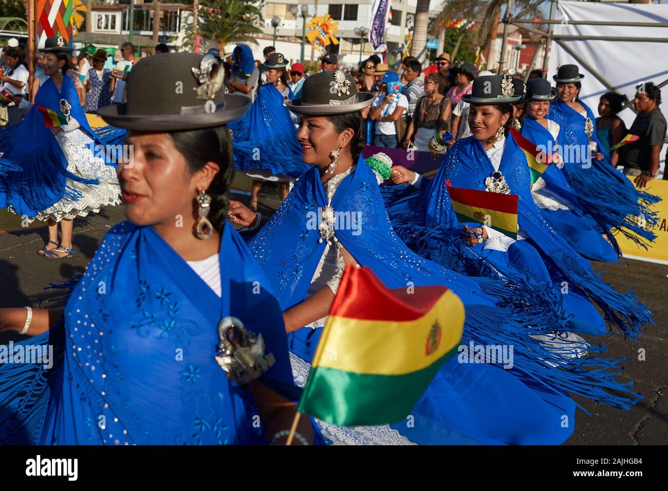 Female members of a Morenada dance group in ornate costumes performing ...