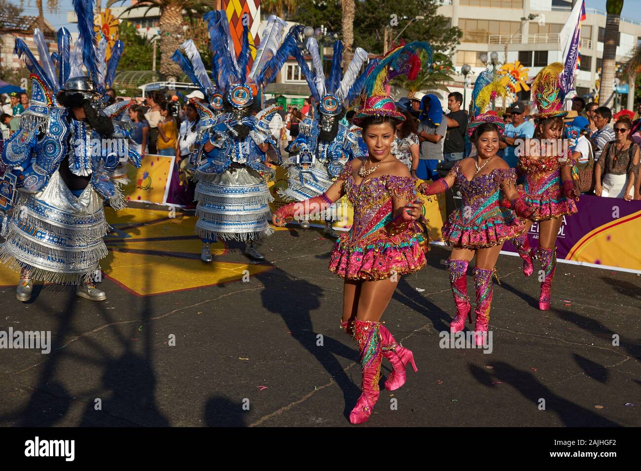 Female members of a Morenada dance group in ornate costumes performing ...
