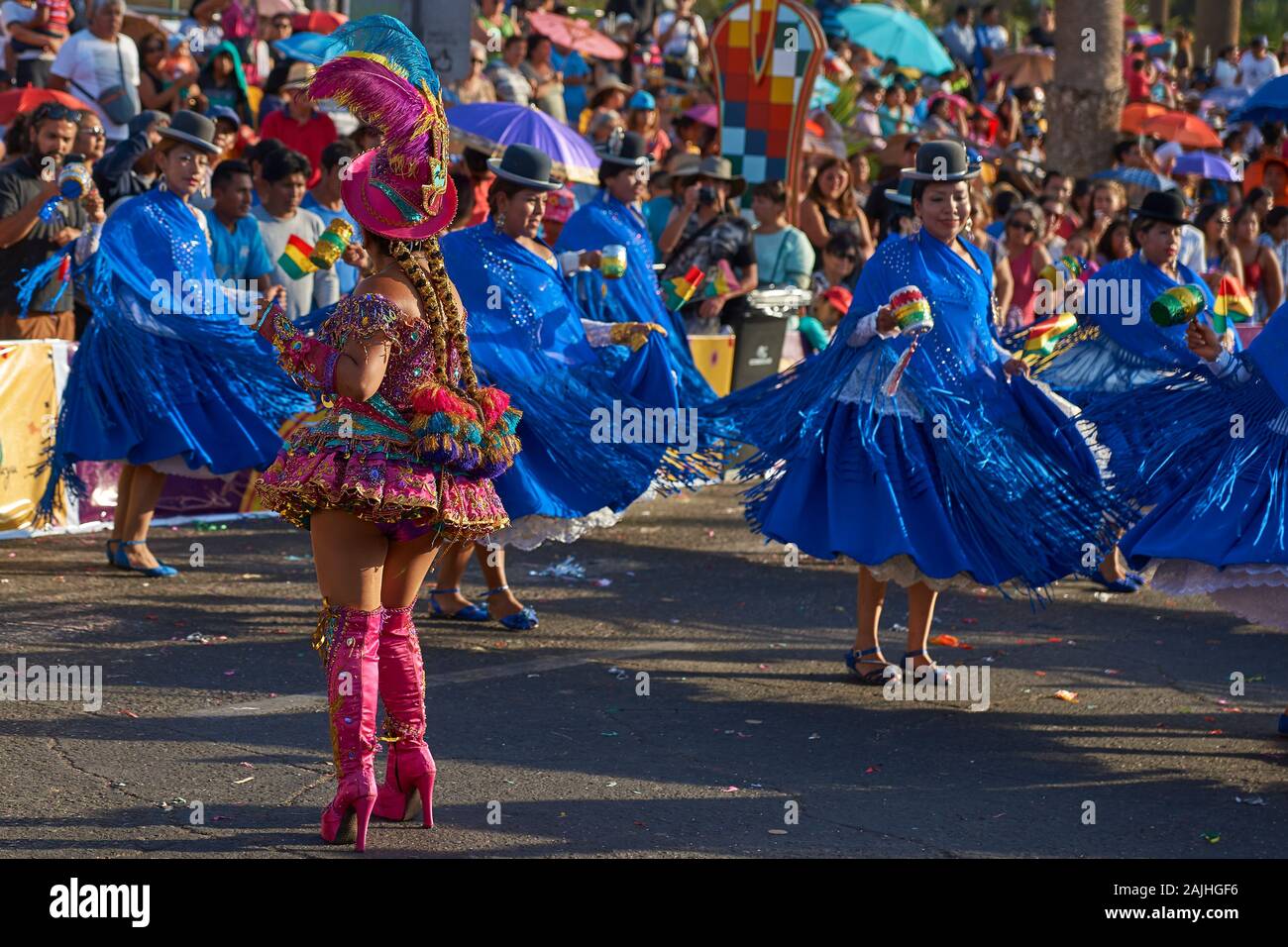 Female members of a Morenada dance group in ornate costumes performing ...