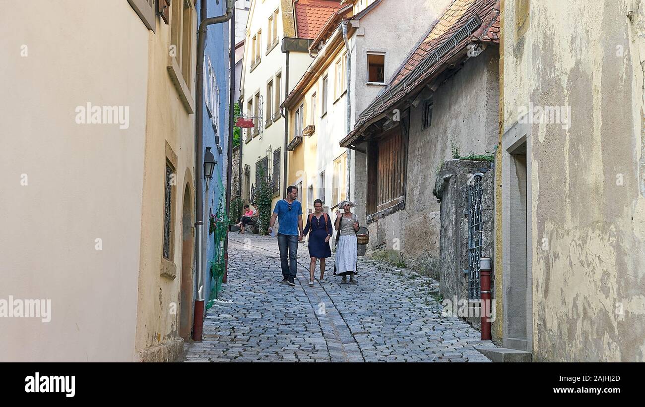 Private tour guide dressed in medieval clothing takes a couple on a ...
