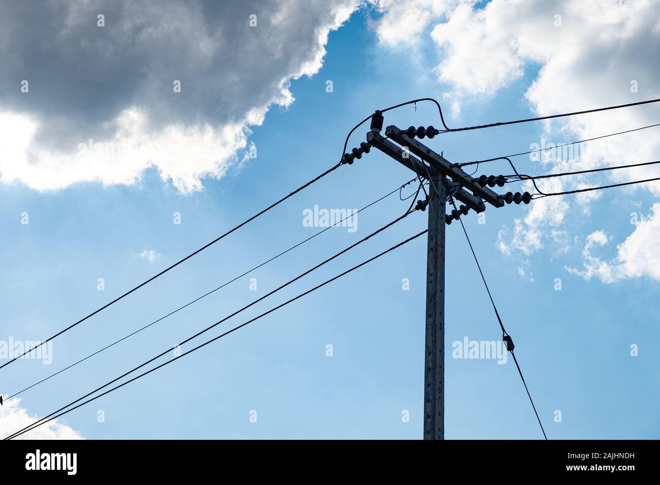 Electricity concrete post and high voltage wire at blue sky background ...