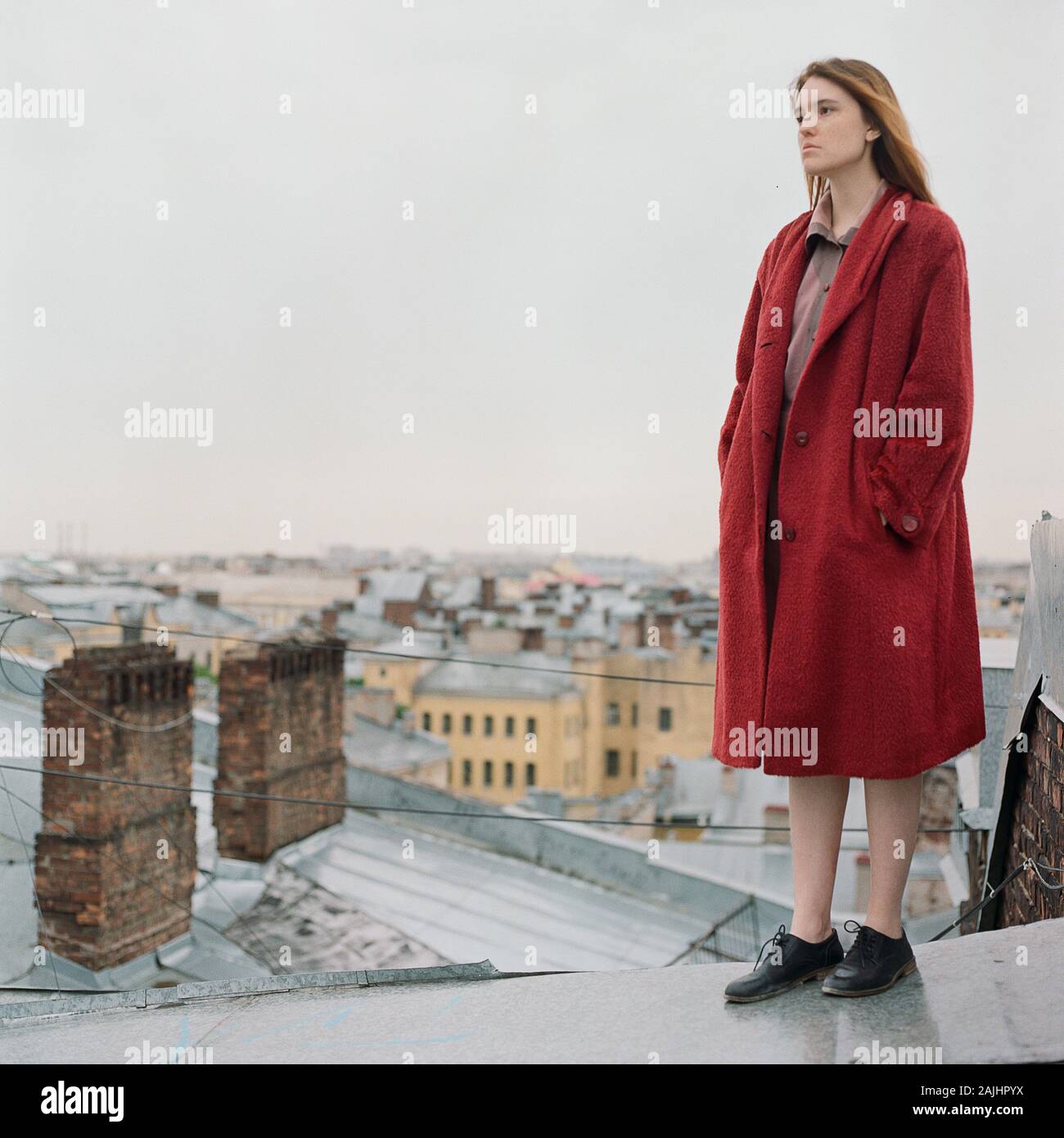 Beautiful woman standing on the roof Stock Photo - Alamy