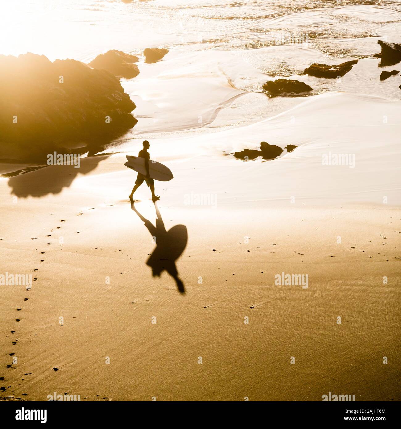 Man walking with a surf board hi-res stock photography and images - Alamy