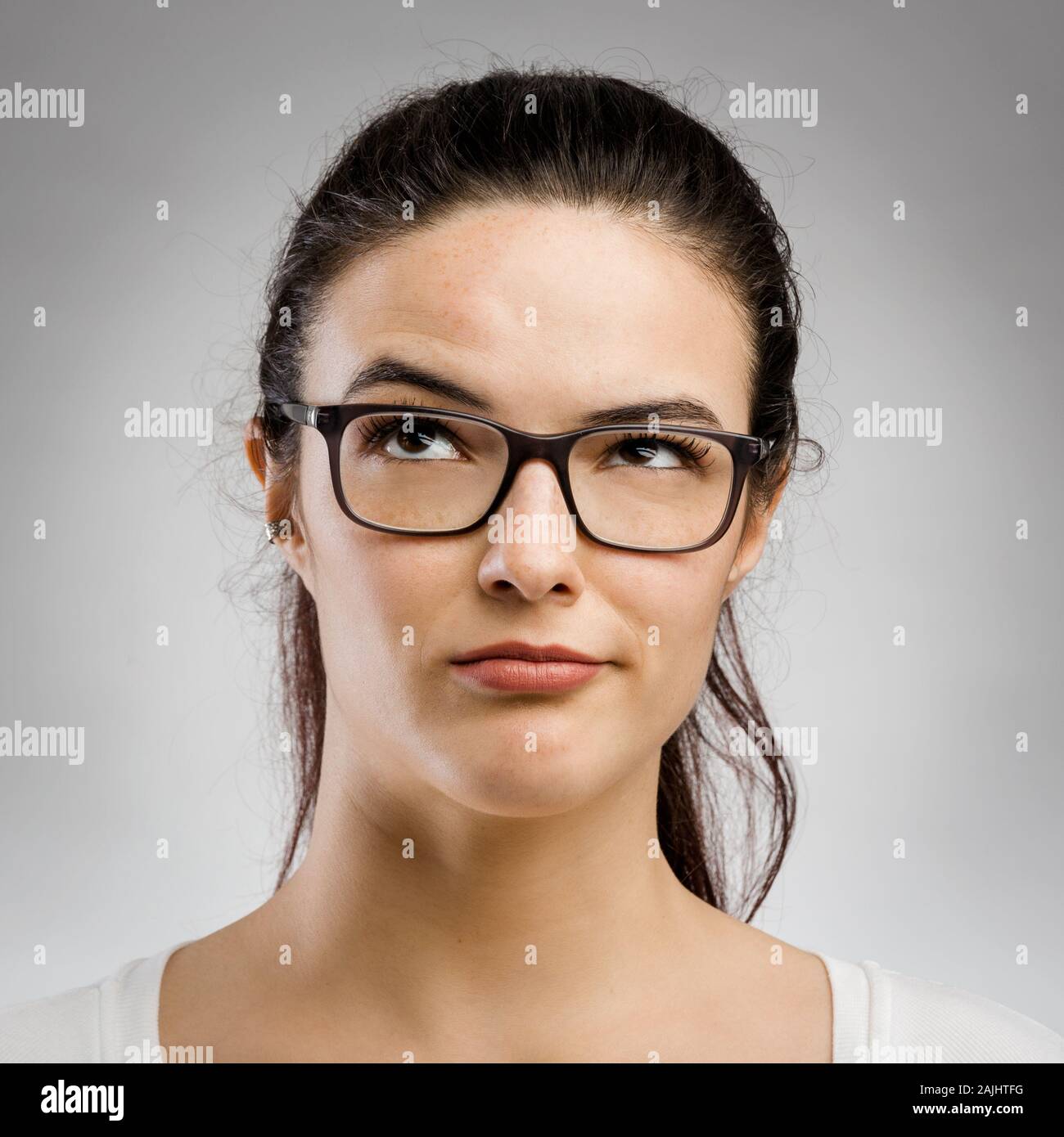 Portrait of a beautiful young woman with a thinking expression Stock ...