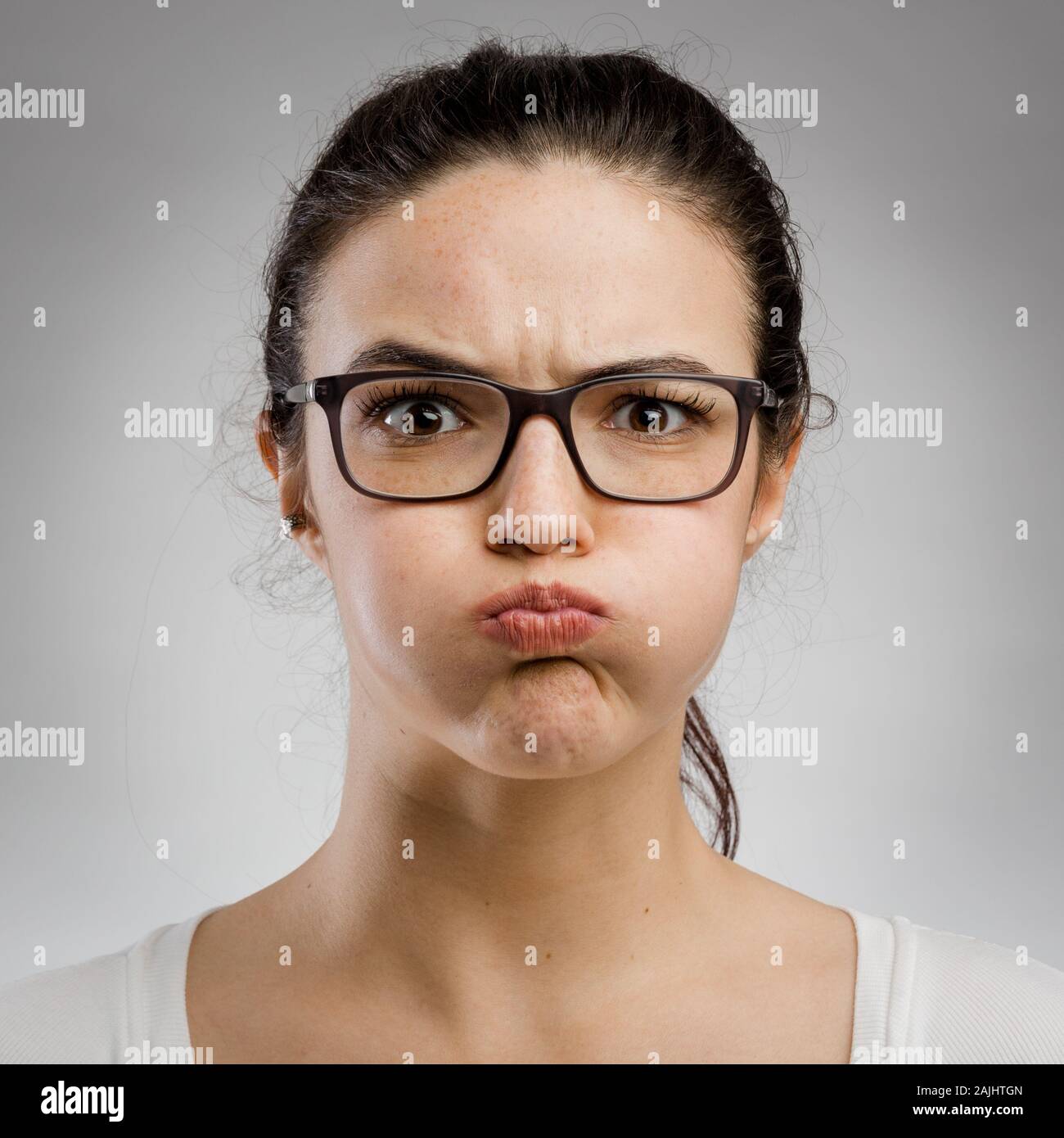 Cute portrait of a woman with a mad expression Stock Photo - Alamy