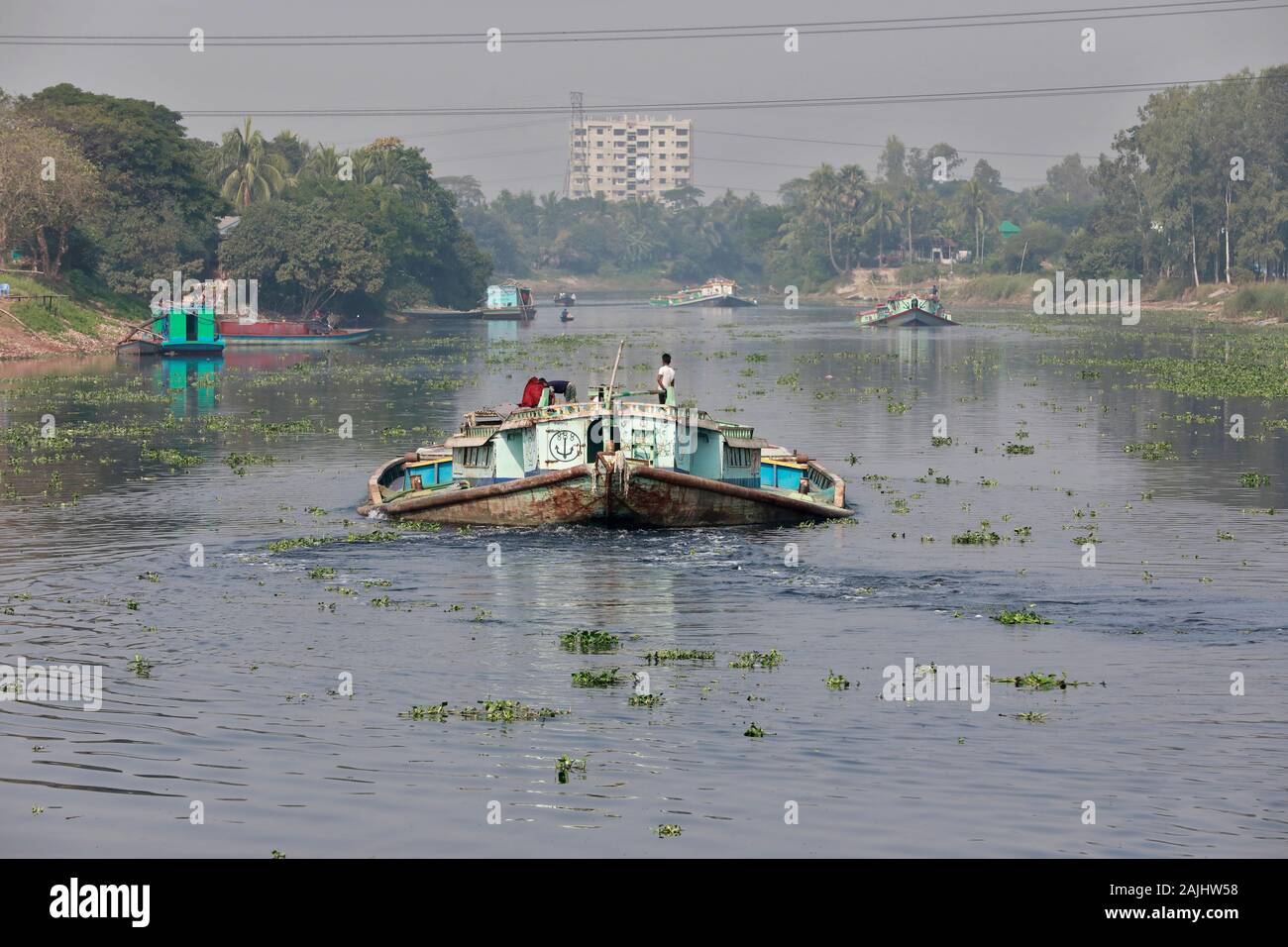 Dhaka, Bangladesh - January 01, 2020: A boat moves over the river balu ...
