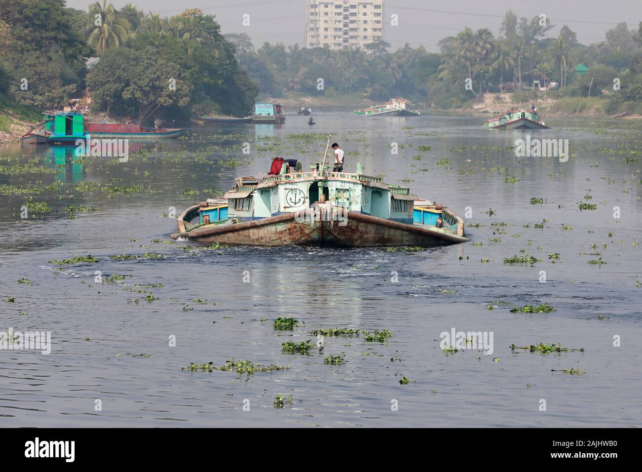 Dhaka, Bangladesh - January 01, 2020: A boat moves over the river balu ...